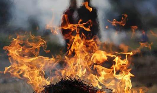 Woman's body removed from burning pyre as police suspect foul play ...